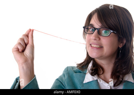 Portrait of businesswoman pulling chewing gum, smiling Stock Photo ...