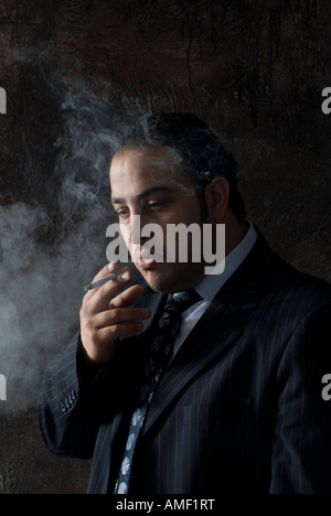 Businessman under stress smoking in office Stock Photo - Alamy
