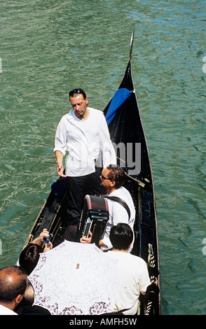 Music boat on the Grand Canal in Venice. The musicians are sitting in a ...