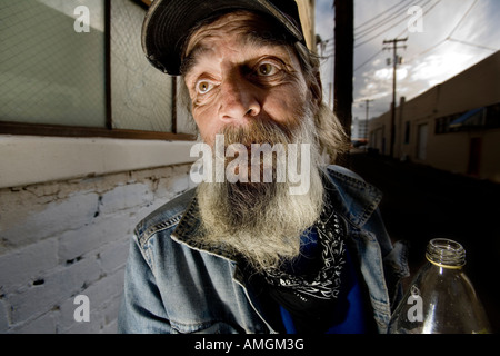 Homeless man drinks 40 oz beer in ally Stock Photo - Alamy