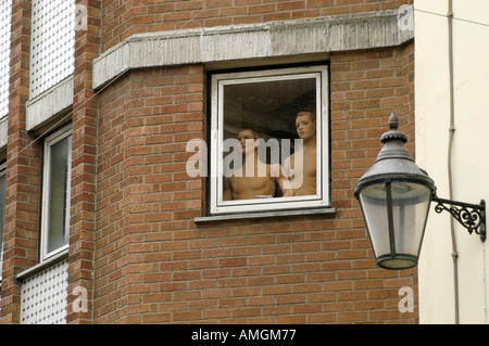two dummies looking out of a storeroom window Stock Photo - Alamy