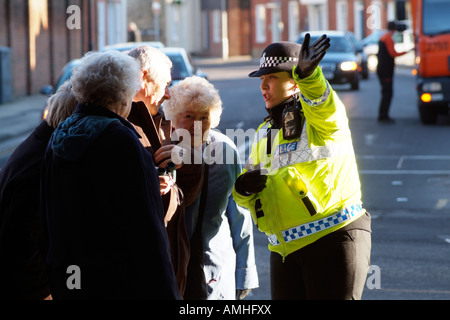 Police officers giving directions to a woman. London. England. UK Stock ...