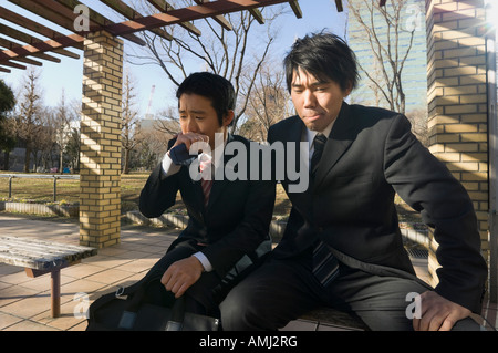 Businessman being consoled Stock Photo - Alamy