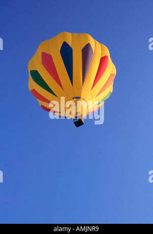 Multicolored air balloon in clear blue sky Stock Photo - Alamy