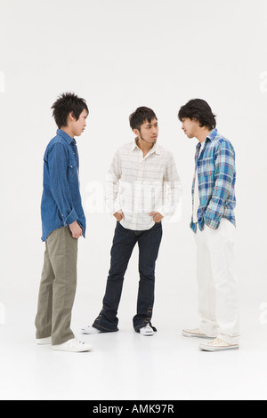 Three young people glaring at each other Stock Photo - Alamy