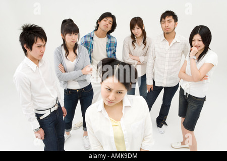 Young woman excluded from group of people Stock Photo - Alamy