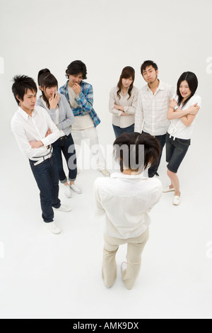 Young woman excluded from group of people Stock Photo - Alamy
