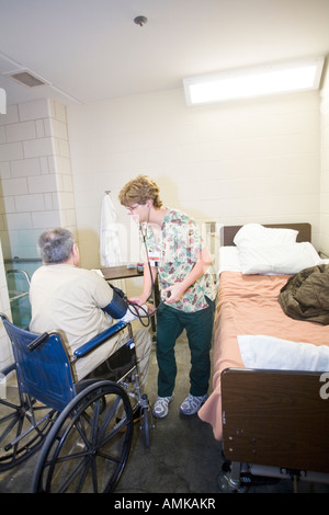 Nurse checking blood pressure of inmate as part of the intake process ...