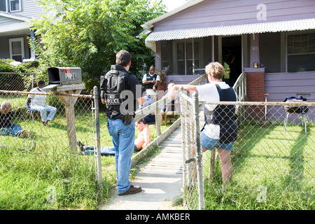 ATF agent and female police officer keeps watch over handcuffed female ...