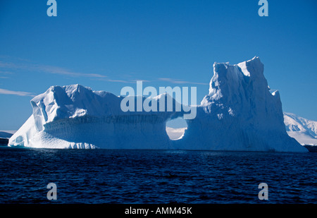 Weathered iceberg with a circular window near Booth Island Stock Photo ...