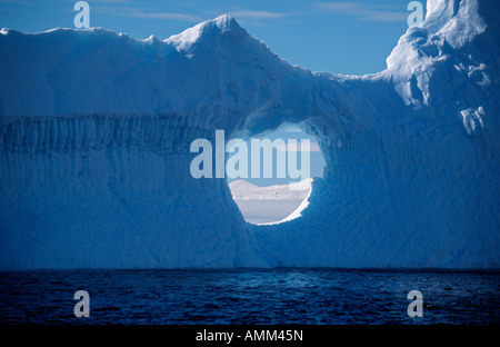 Weathered iceberg with a circular window near Booth Island Stock Photo ...