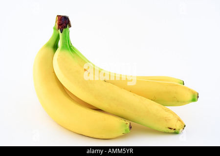 Bundle of fresh, yellow, ripe bananas in white wooden box on wood table ...
