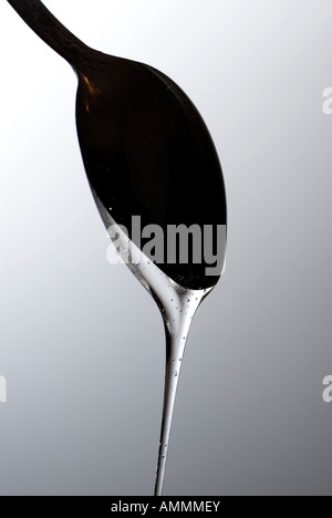 syrup spilling into a spoon Stock Photo - Alamy