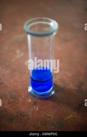 Blue copper sulfate solution in a conical flask on a laboratory bench ...
