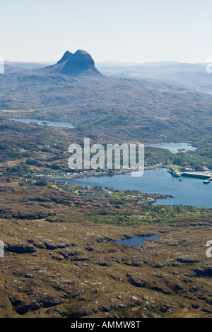 An aerial view of Lochinver with harbour visible and mountain of Canisp ...
