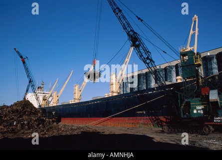 Crane loading scrap metal onto cargo ship, Newhaven, Sussex, UK Stock ...