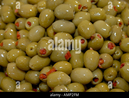 Green olives stuffed with red pimento in small white bowl Stock Photo ...