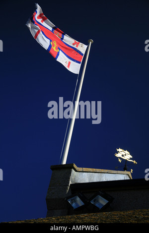 RNLI flag flying in the breeze Amble harbour Northumberland UK Stock ...