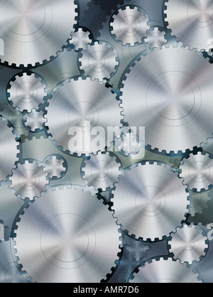 Metal cogs interlinked Stock Photo - Alamy