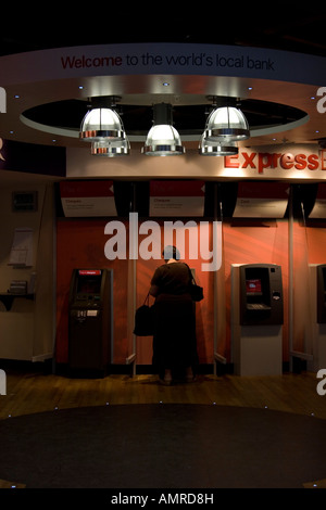 a woman bank teller at HSBC bank, UK Stock Photo - Alamy
