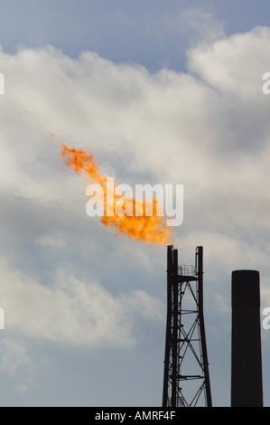 Gas flare stack burning waste gas from the SSI steel factory at Redcar ...