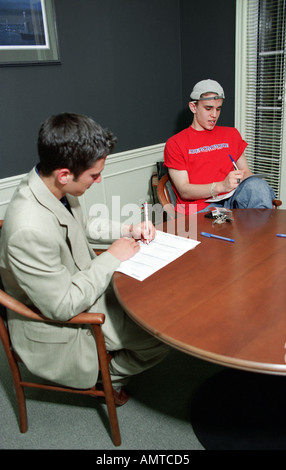 Two job applicants one appropriately dressed one not fill out an ...