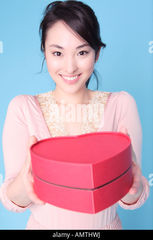 Woman having heart shaped box Stock Photo - Alamy