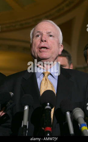 U.S. Senator John McCain, R-AZ, left, talks with aids as he ascends an ...