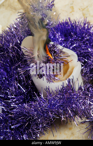 Candle catches fire to christmas tinsel Stock Photo - Alamy