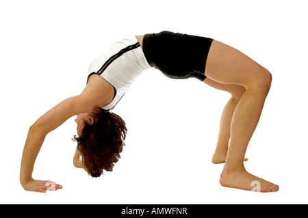 Athletic woman performing bridge position. Yoga pose dhanurasana ...