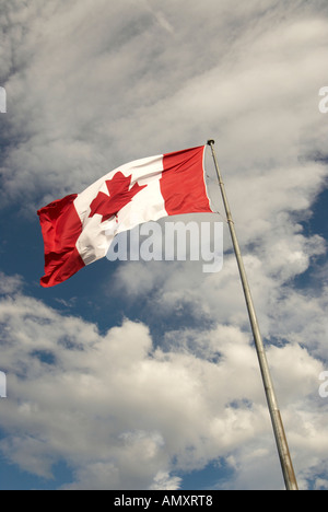 Canadian Flag with a dramatic, cloudy blue sky Stock Photo - Alamy