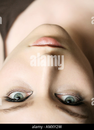 Inverted colors portrait of a young woman with curly hair, showing the ...