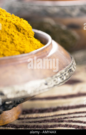 close up yellow powder color on wooden spoon. colourful powder paint in ...