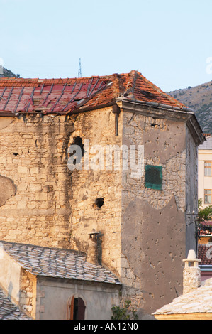 A derelict bomb damaged ruin still remaining from the war in Bosnia on ...