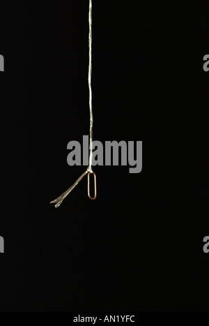 one paperclip tied to piece of string Stock Photo - Alamy