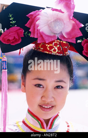A woman dressed in Qing Dynasty attire poses for a souvenir photograph ...