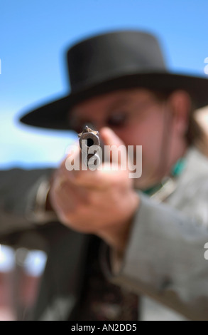 Man pointing hand gun directly at camera Stock Photo - Alamy