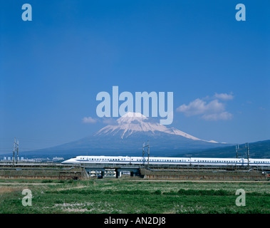 JAPAN Honshu Mount Fuji Shinkansen Bullet Train passing through harvested rice fields below the ...