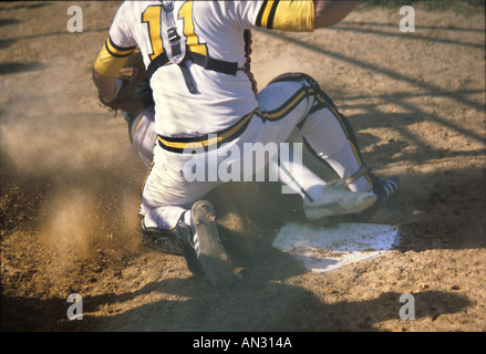 Baseball Catcher behind home plate. Shot from behind a chain link fence ...
