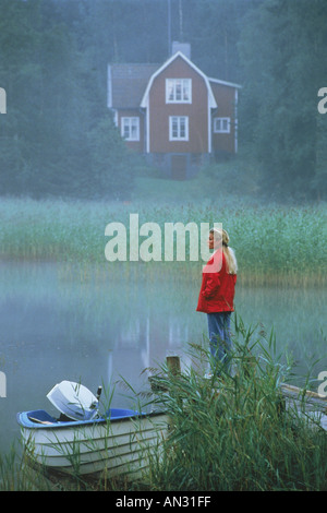 evening mood at the lake with a boat dock Stock Photo - Alamy