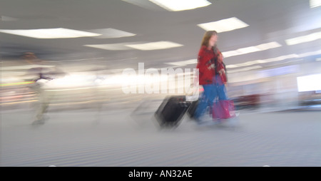 man and woman running through an airport in a rush to catch their Stock ...