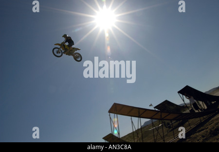 Motocross riders jumping a ramp Stock Photo - Alamy