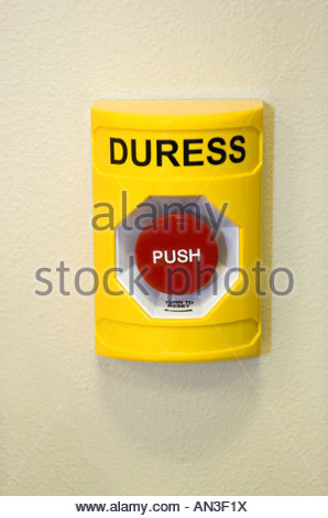 Red duress button on wall Stock Photo - Alamy