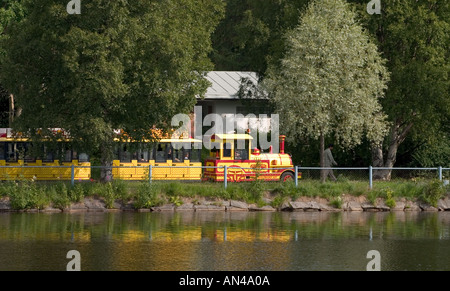 Finnish sightseeing bus / train Potnapekka driving at the riverbank of ...
