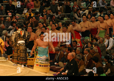 Sumo wrestlers in traditional colourful ceremonial costumes attend the ...
