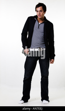 Young handsome man wearing striped t-shirt over yellow isolated ...