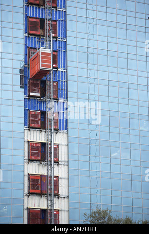 Construction elevators climb the side of a new high rise Stock Photo ...
