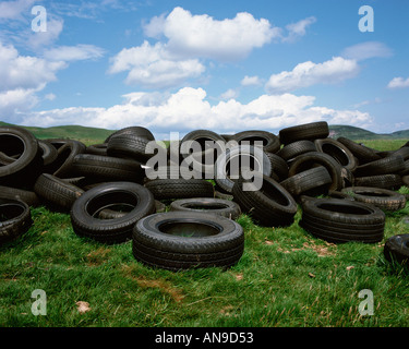 Worn-out tyres are discarded in a quarry, contributing to environmental ...