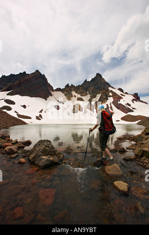 Woman backpacker below Broken Top Stock Photo - Alamy