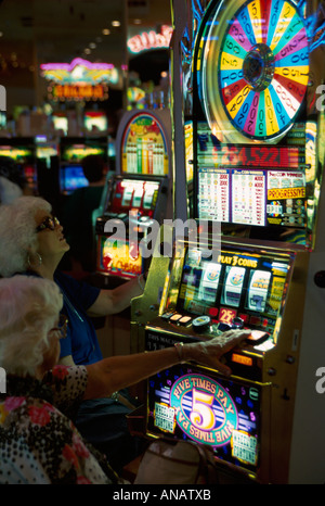 Elderly people gambling on the slot machines in the lobby of a large ...